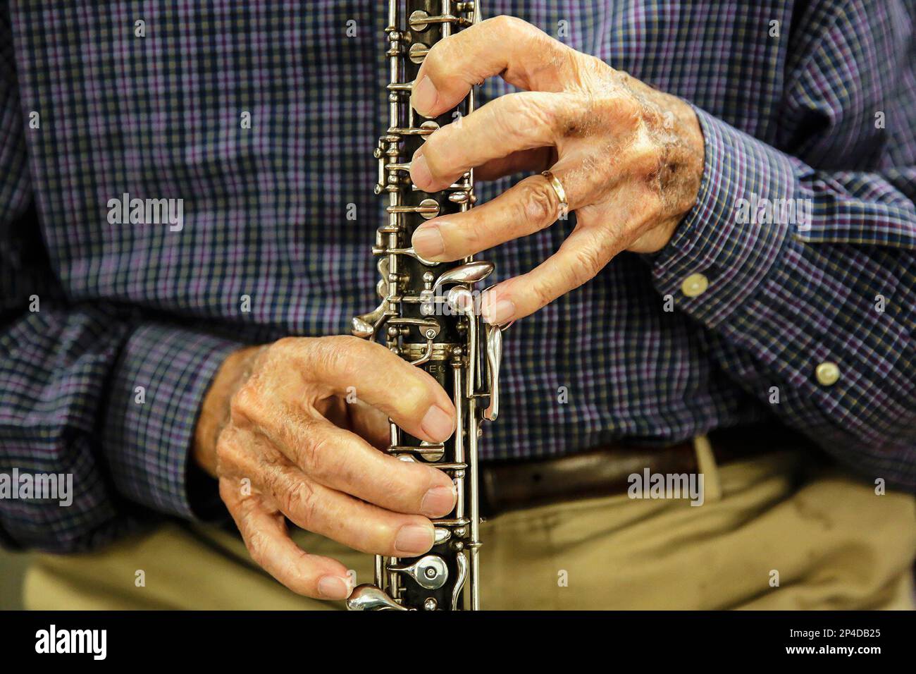 In this May 20, 2014 photo, Robert Moore,93, plays his oboe while ...