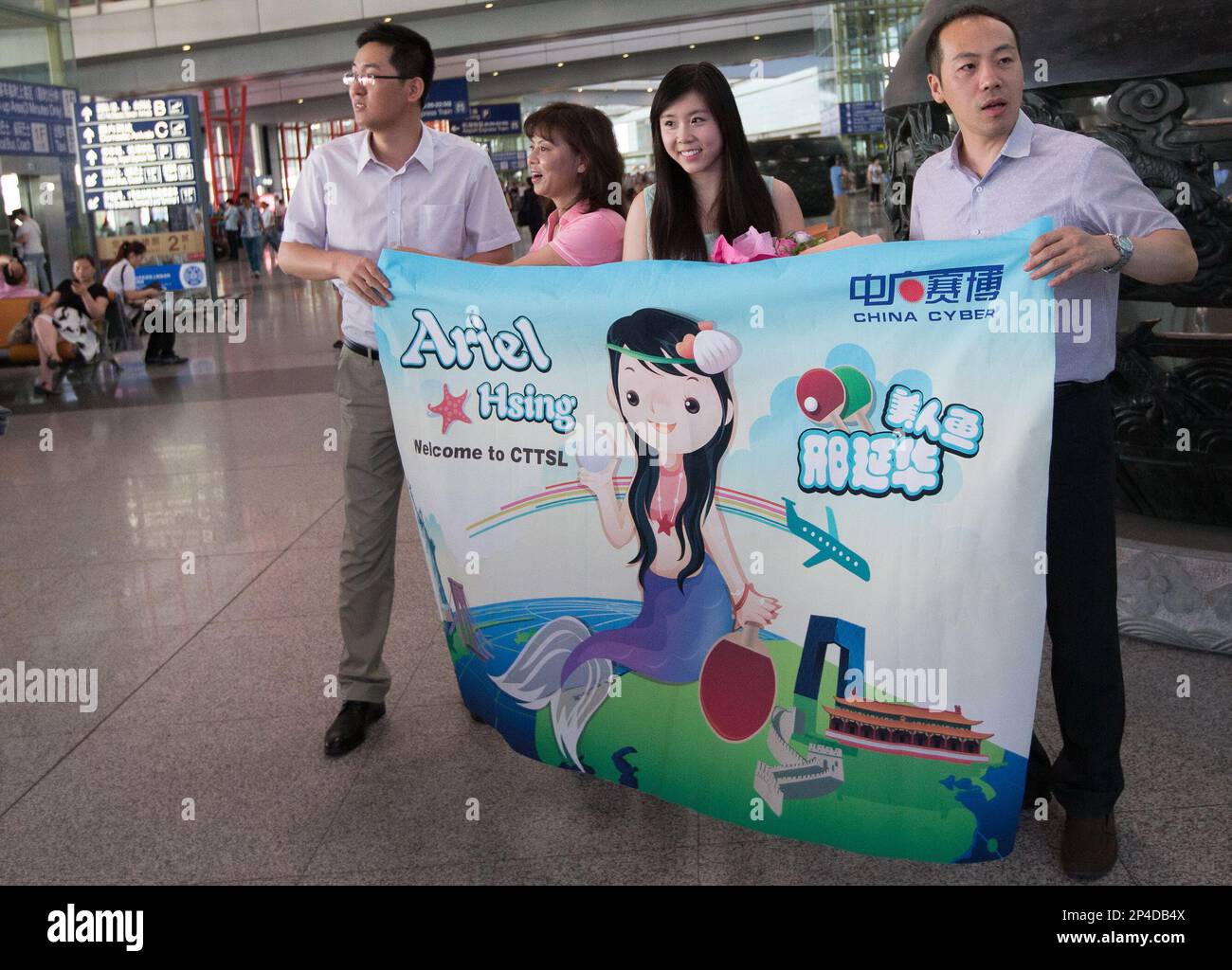 American table tennis player Ariel Hsing, second right, is welcomed ...