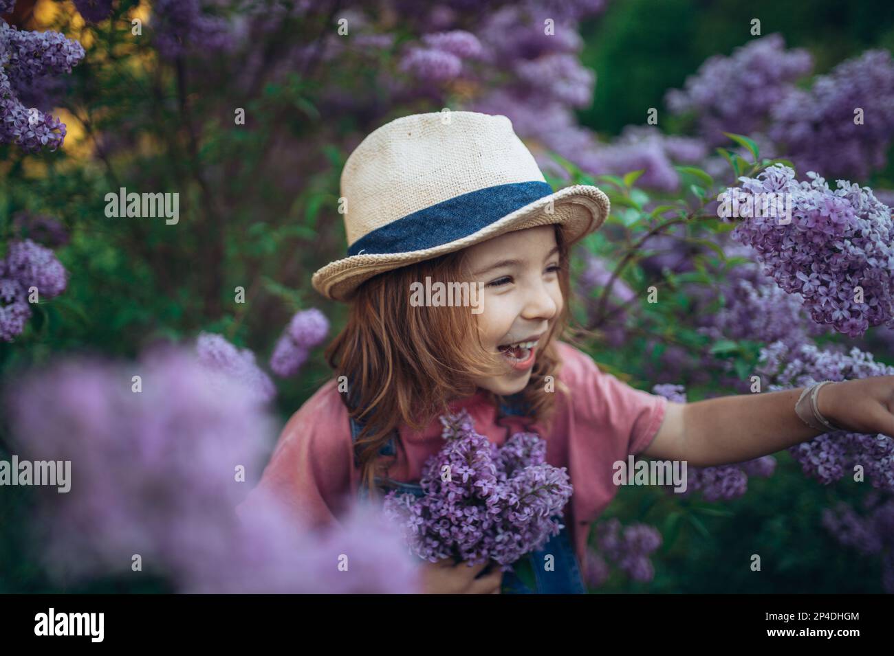 Portrait of little girl with lilac, spring mood Stock Photo - Alamy