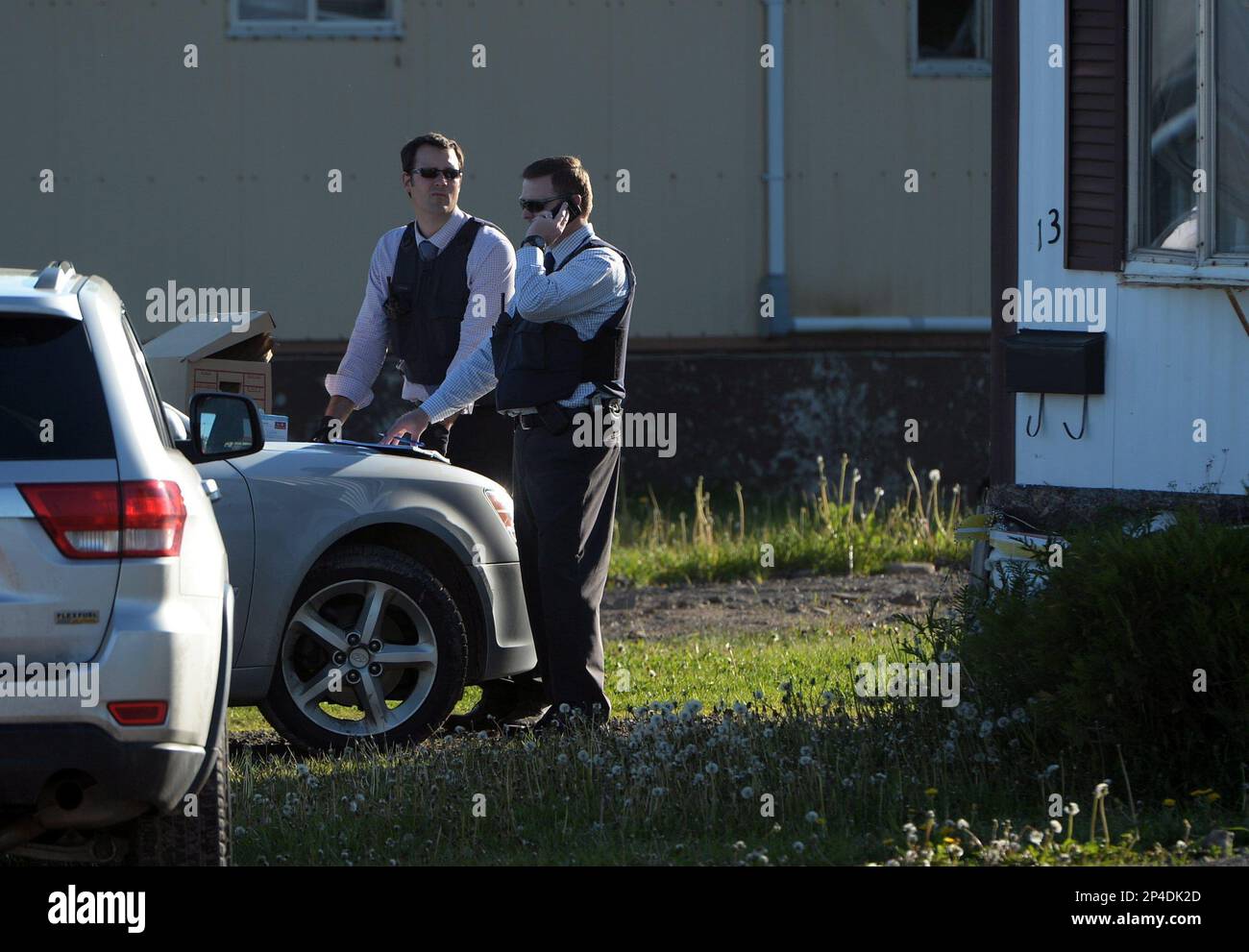 Royal Canadian Mounted Police investigators work at the home of ...