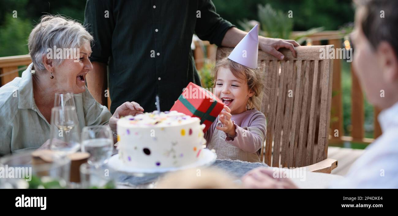 Multi generation family celebrating birthday of little girl and having ...