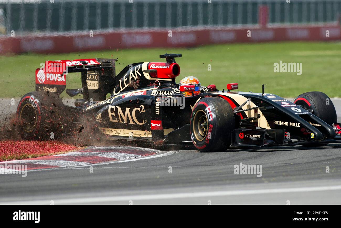 Lotus driver Romain Grosjean from France drives through the grass in ...