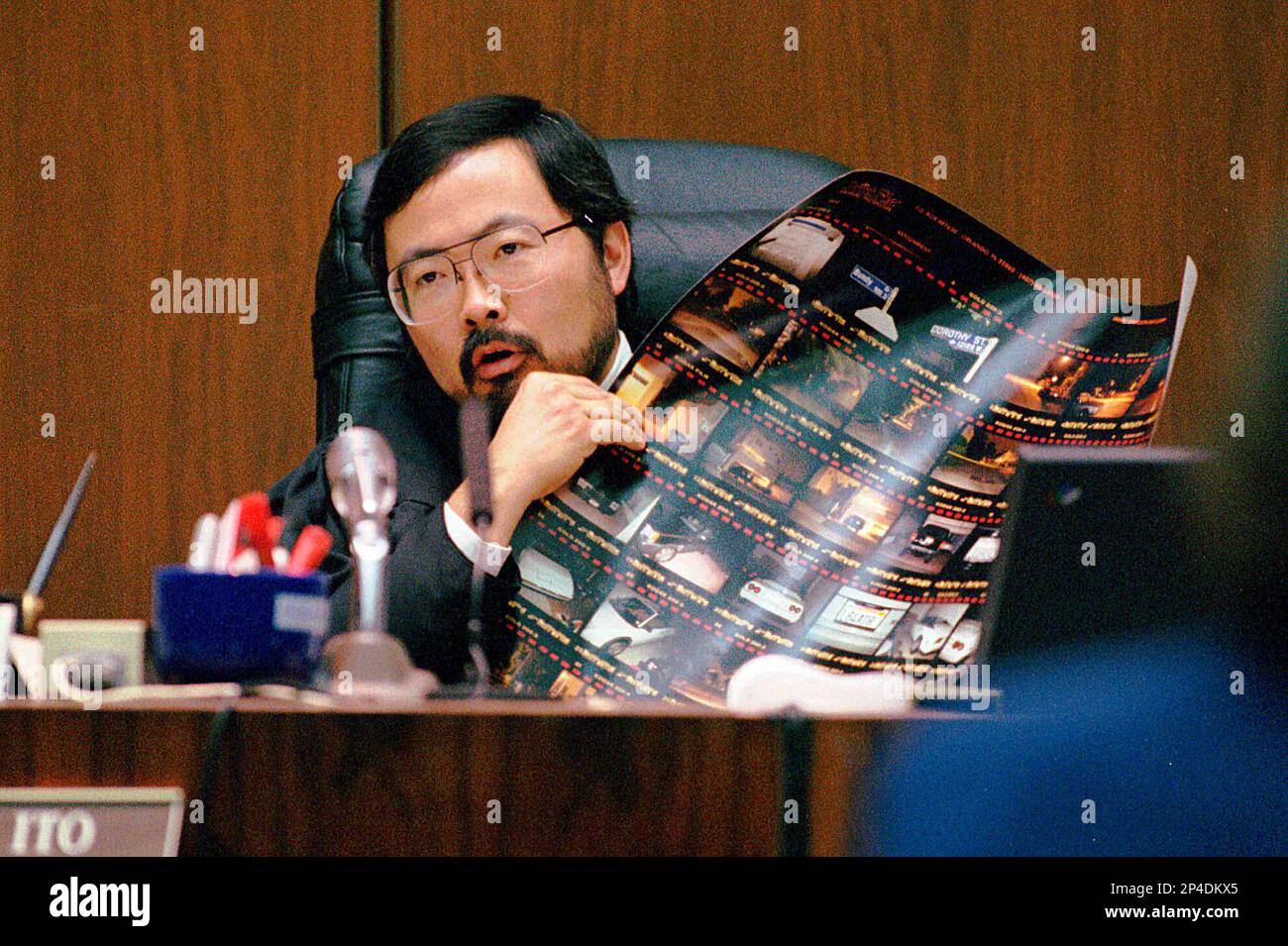 FILE - In this Sept. 7, 1995 file photo, Judge Lance Ito holds up an enlarged proof sheet of ...