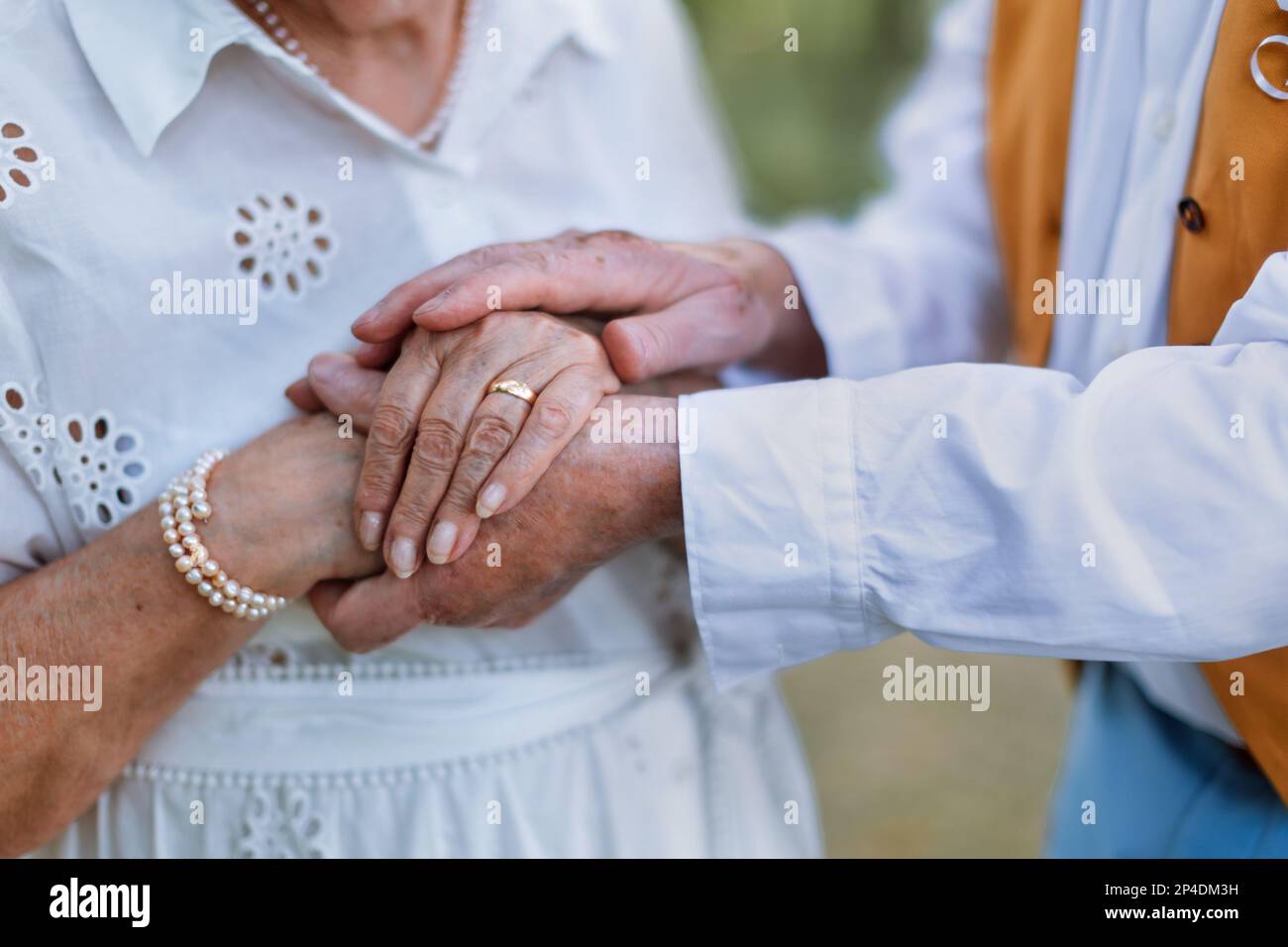 Older hands and wedding rings hi-res stock photography and images - Alamy