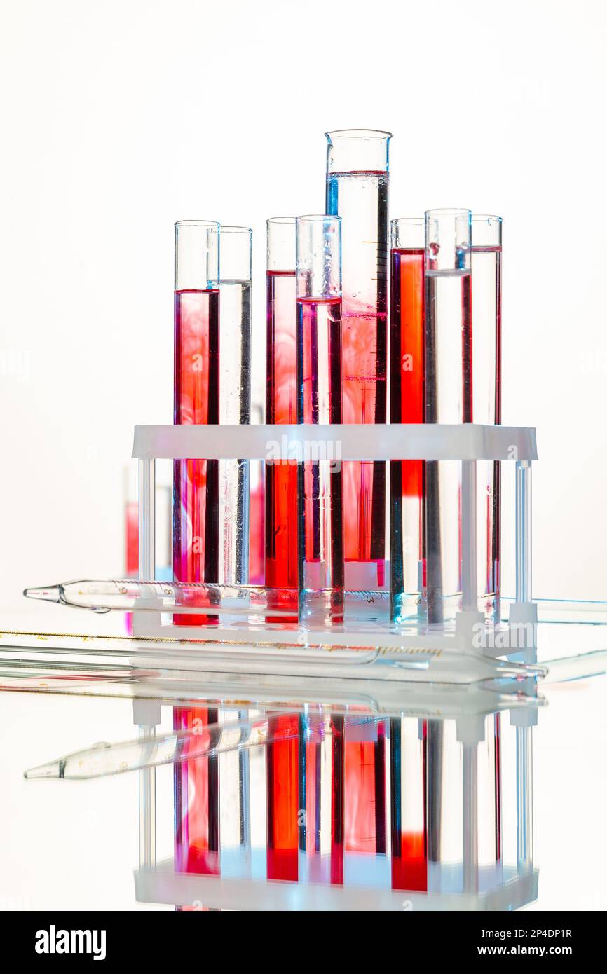 Set of lab test tubes with samples of blood. Vertical shot white ...