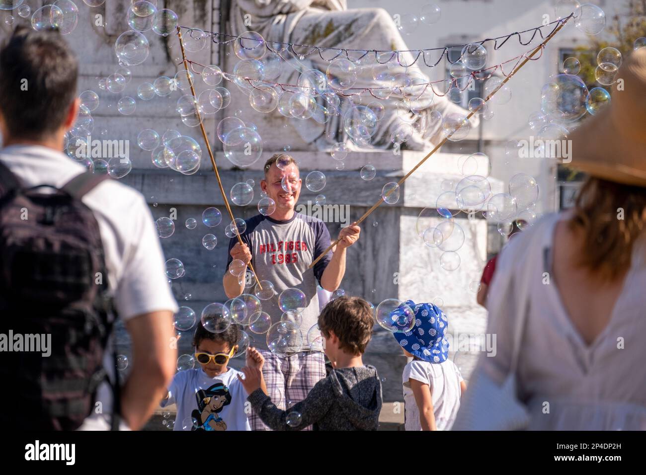 Children playing with bubbles in a park in Lisbon, Portugal Stock Photo ...