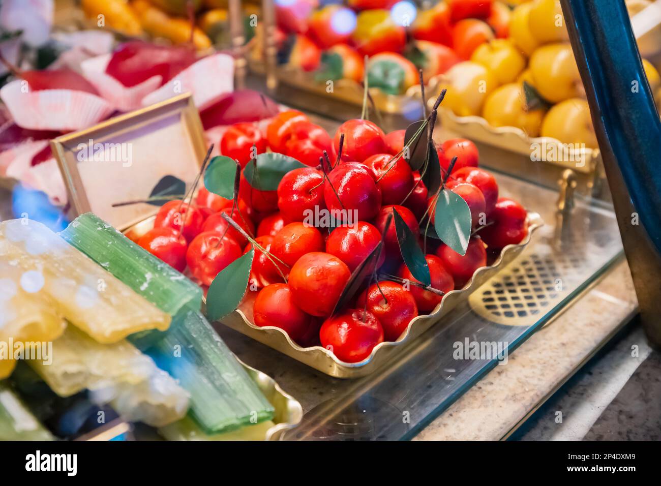 cherry marzipan chocolate candy a lot on shop window, store shelf. Heap ...