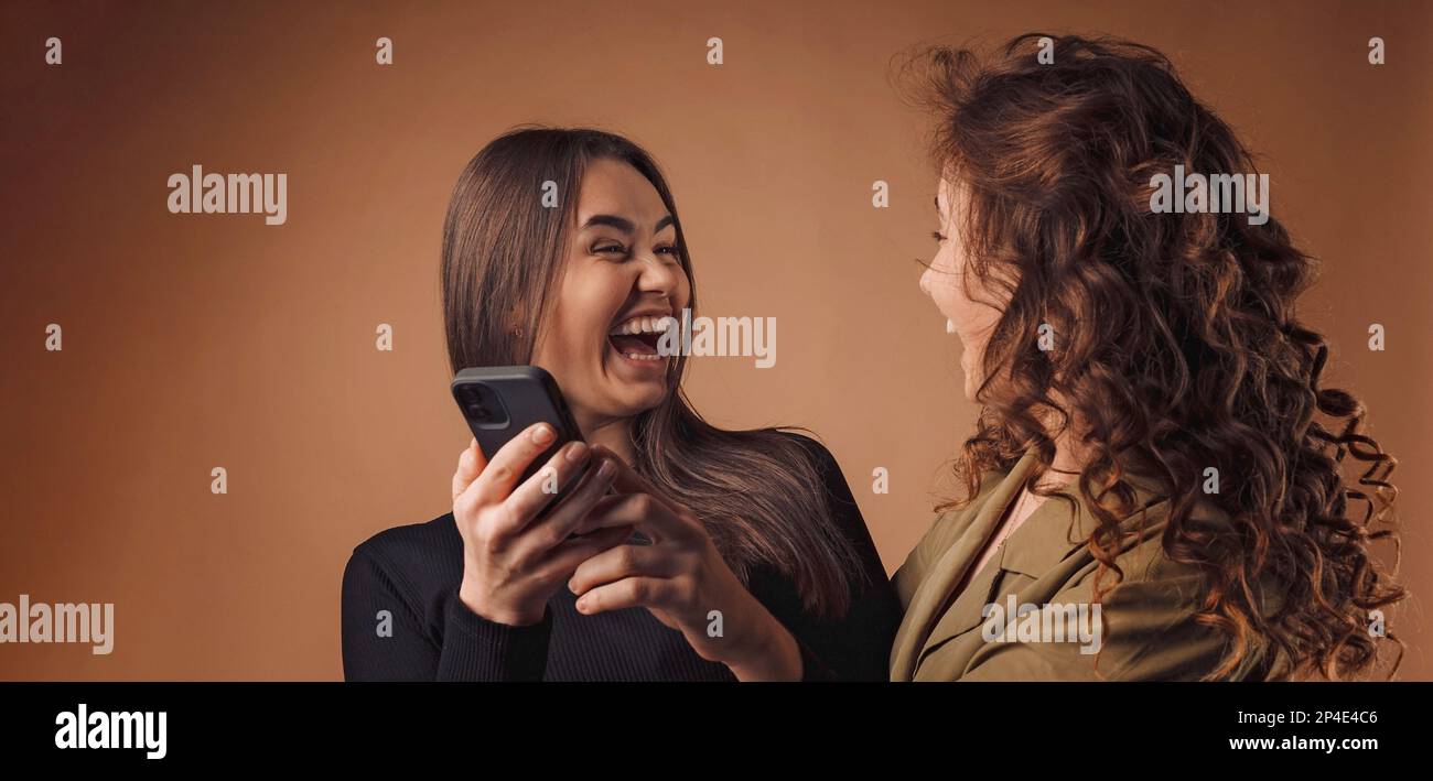Portrait of two young happy girls, studio shoot Stock Photo - Alamy
