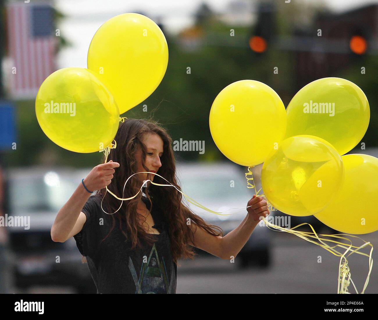 Rachel Malone, 17, ties balloons along Main Street in Hailey, Idaho on ...