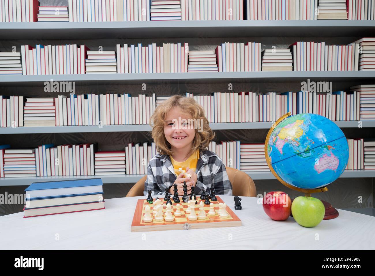 Child play chess at school. Clever concentrated and thinking child ...