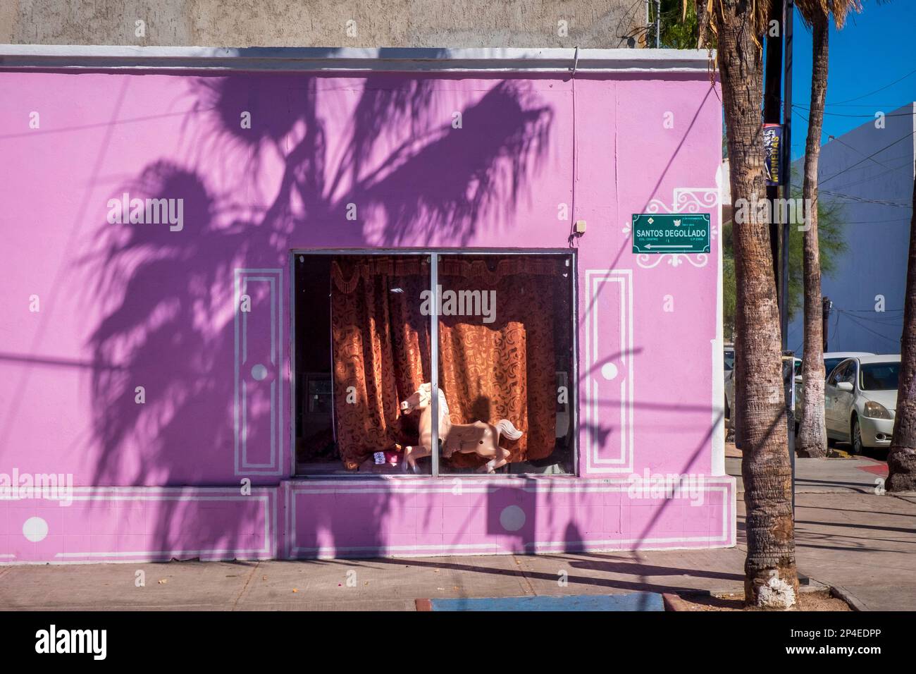 Toy rocking horse in a window, La Paz, Baja California, Mexico, pink ...