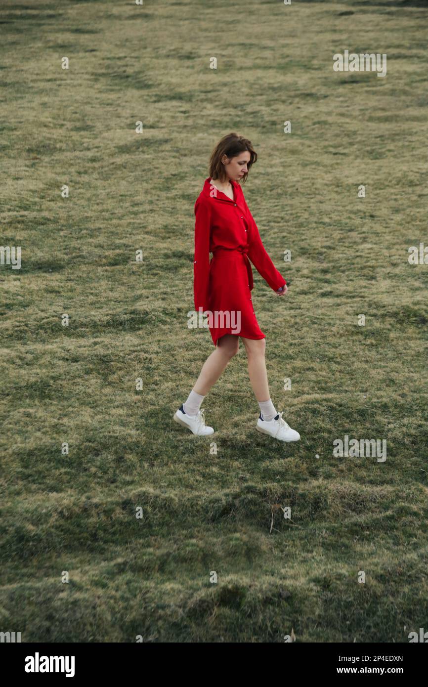 Woman in red summer dress walking hi-res stock photography and images ...