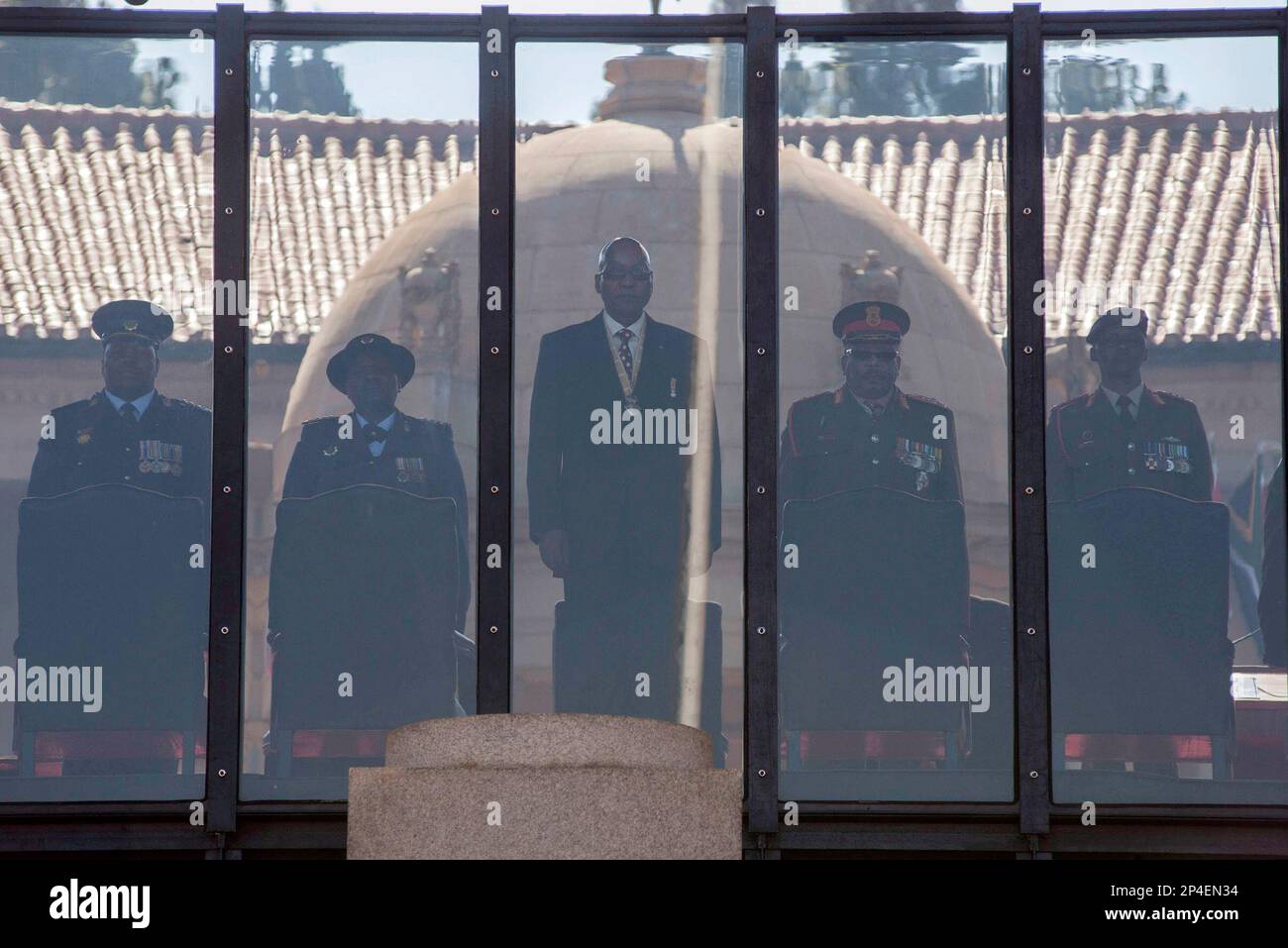 President Jacob Zuma, center, behind bullet proof glass, stands to ...