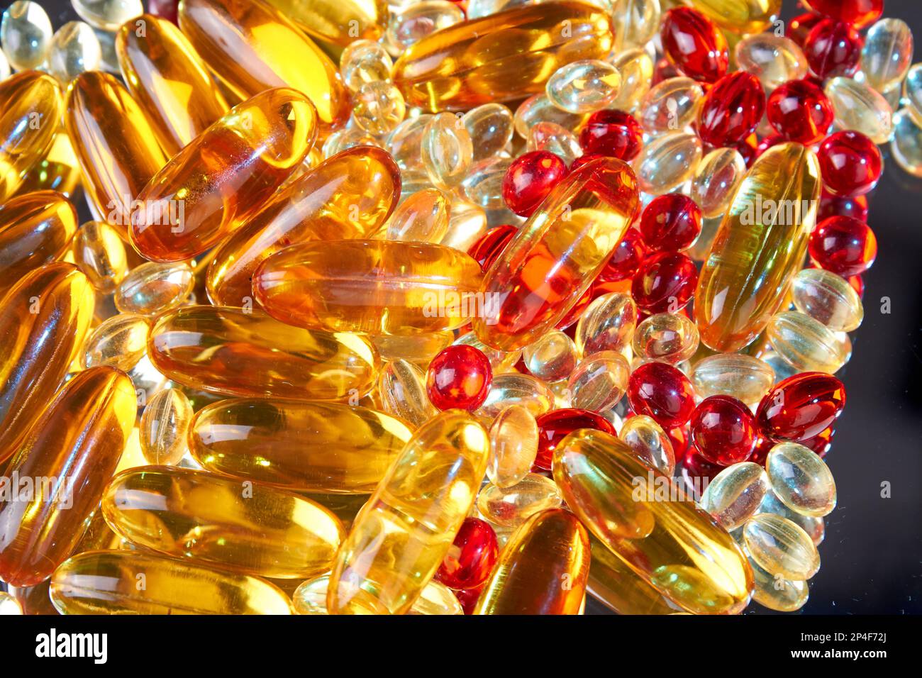 Close up pile of golden capsules of vitamin D3. Biologically active ...