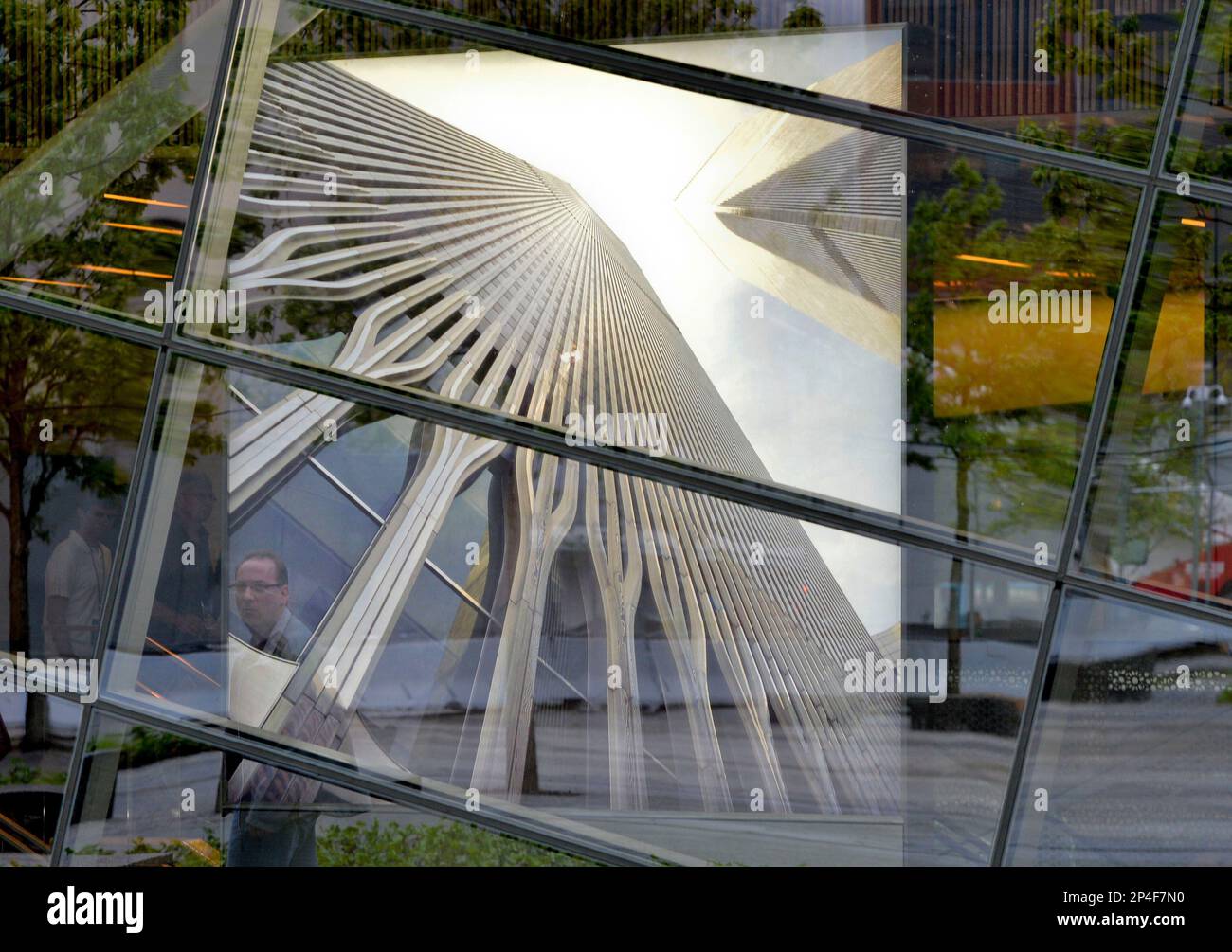 A man, left, looks a picture of the original World Trade Center towers ...