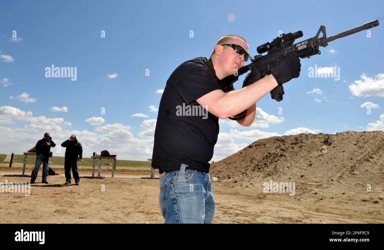 Mike Recor aims down the sight of his rifle during a visit to the Baker ...