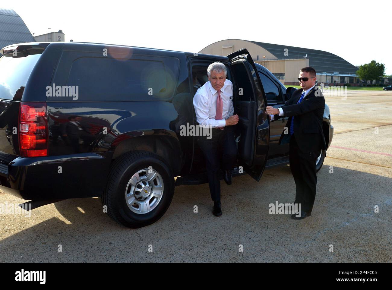 Defense Secretary Chuck Hagel arrives to board a flight at Andrews Air ...