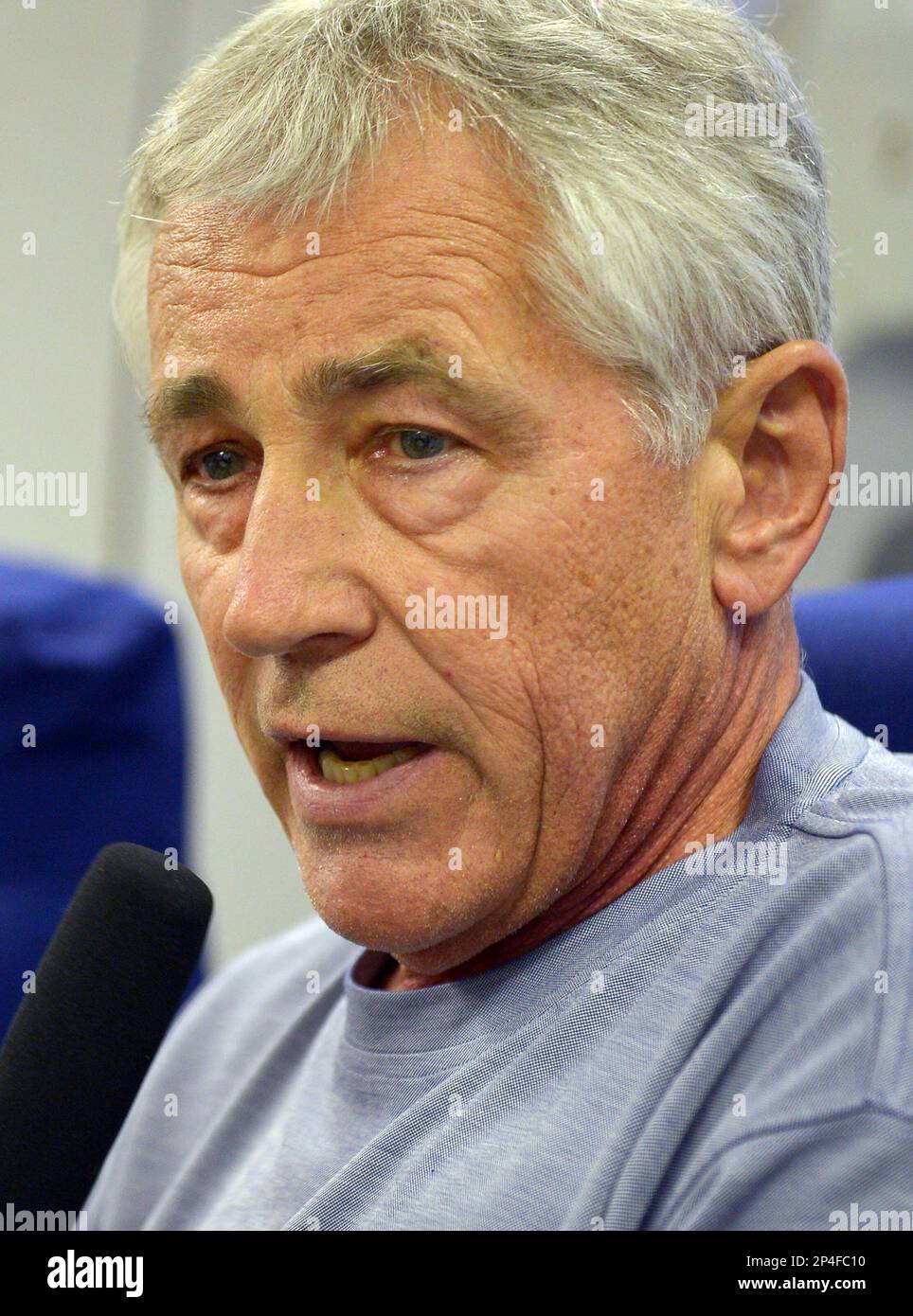 Defense Secretary Chuck Hagel speaks during a briefing onboard a flight ...