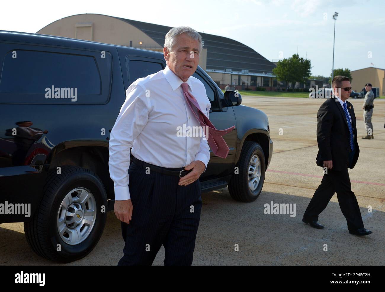 Defense Secretary Chuck Hagel arrives to board a flight at Andrews Air ...