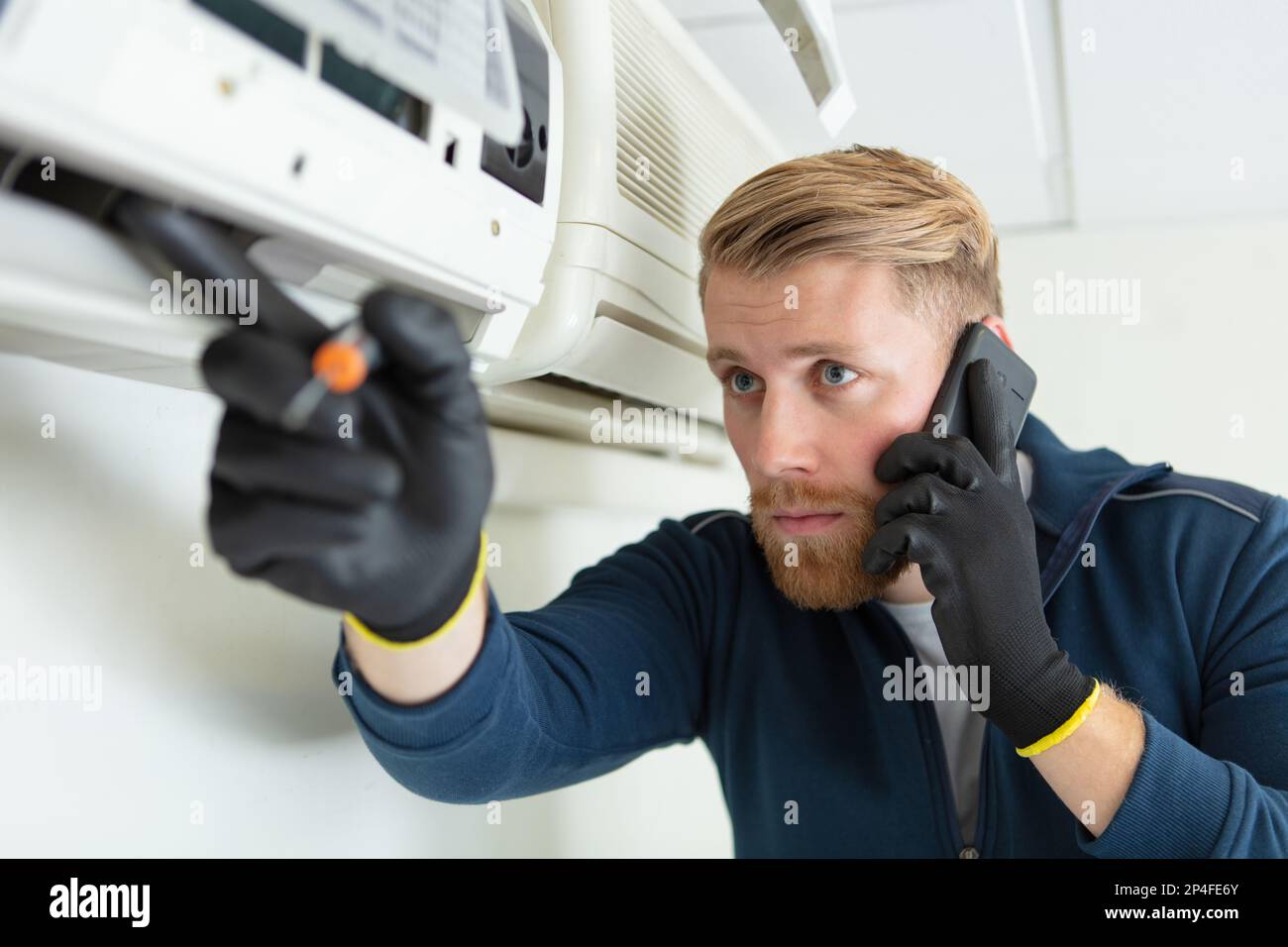 male technician repairing air conditioner outdoors Stock Photo - Alamy