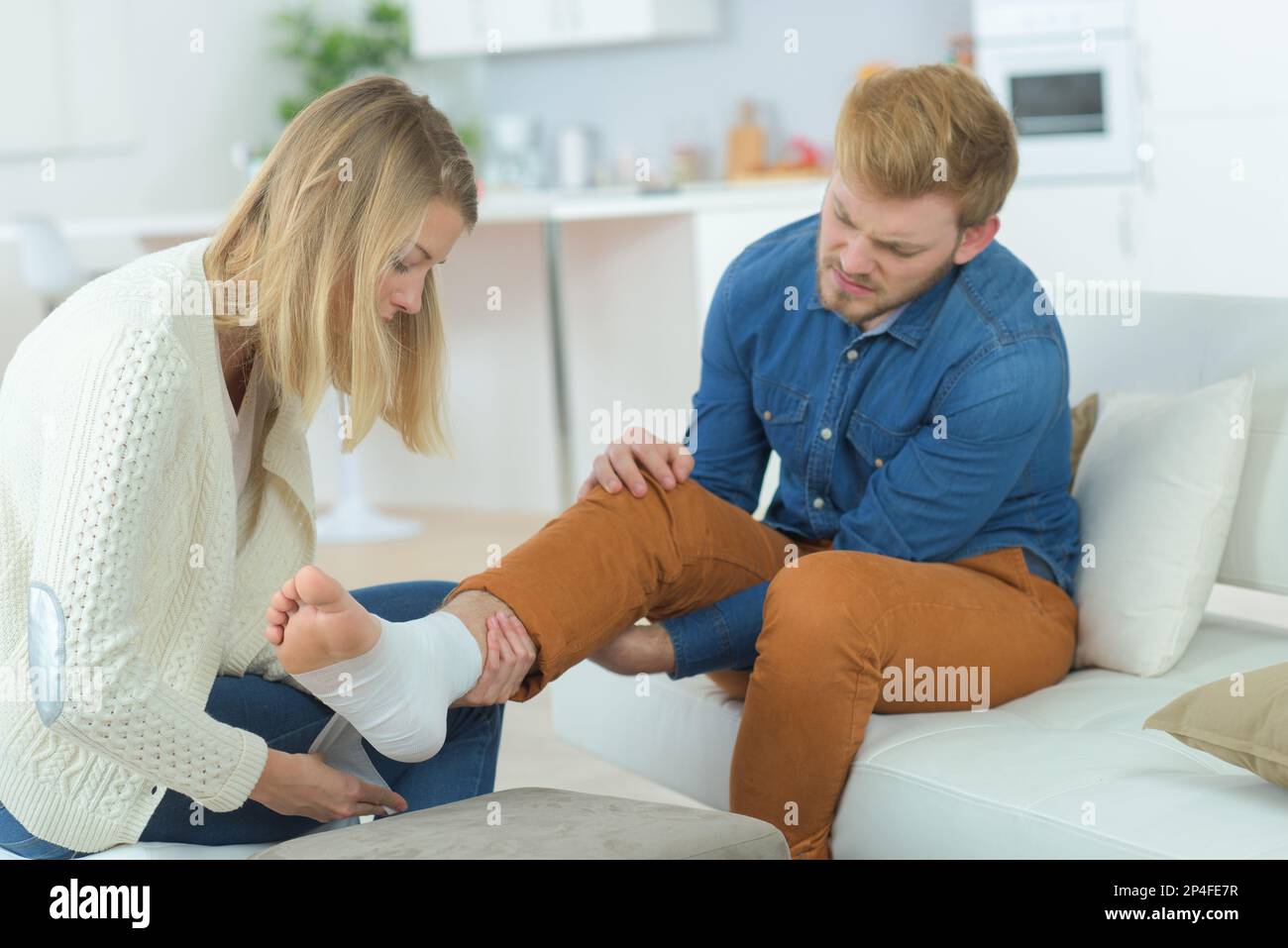 Bandaging foot woman hi-res stock photography and images - Alamy
