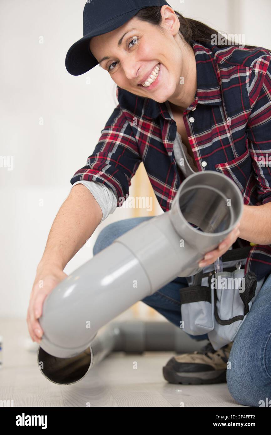 female plumber connecting plastic pipes Stock Photo - Alamy