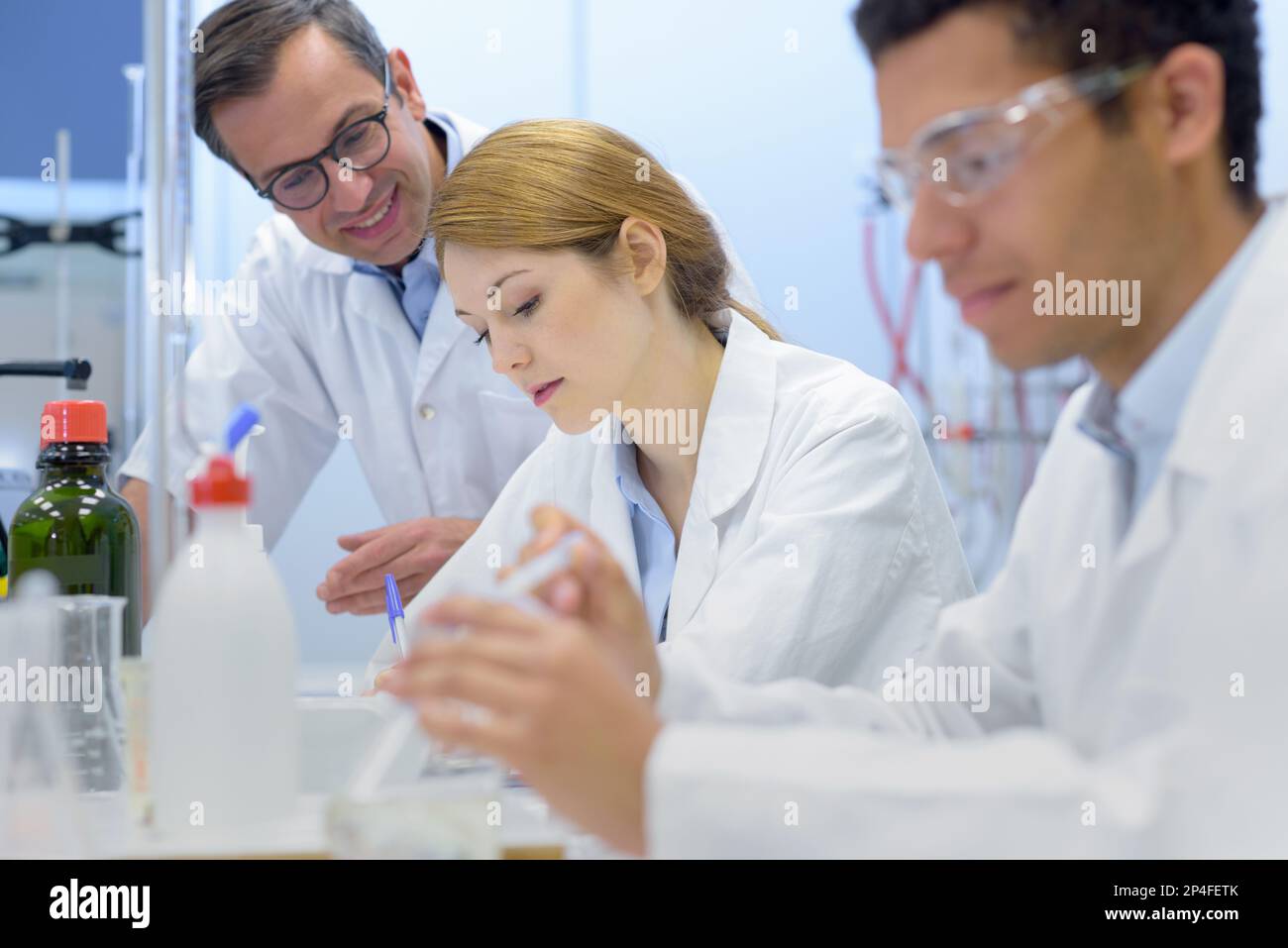 students and teacher experimenting in the lab Stock Photo - Alamy