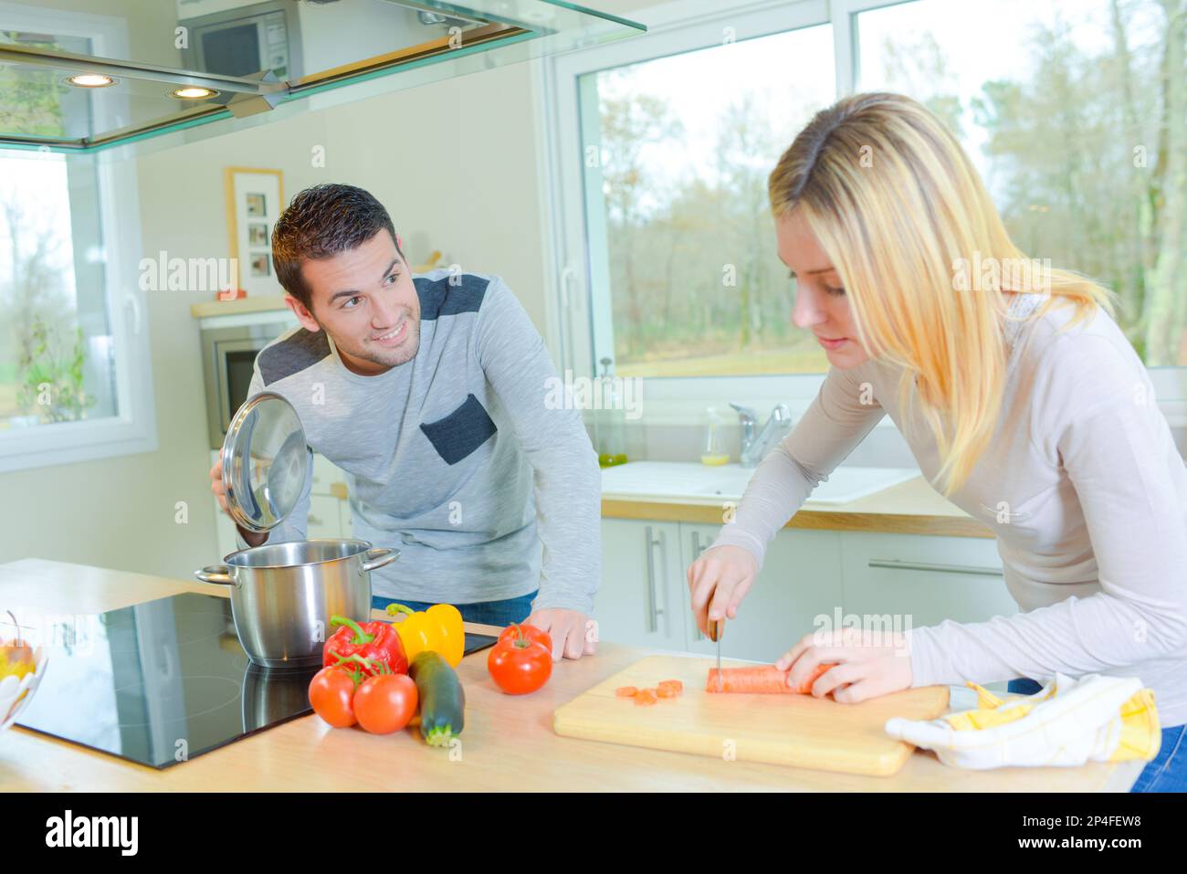 a couple is opening the pot lid Stock Photo - Alamy