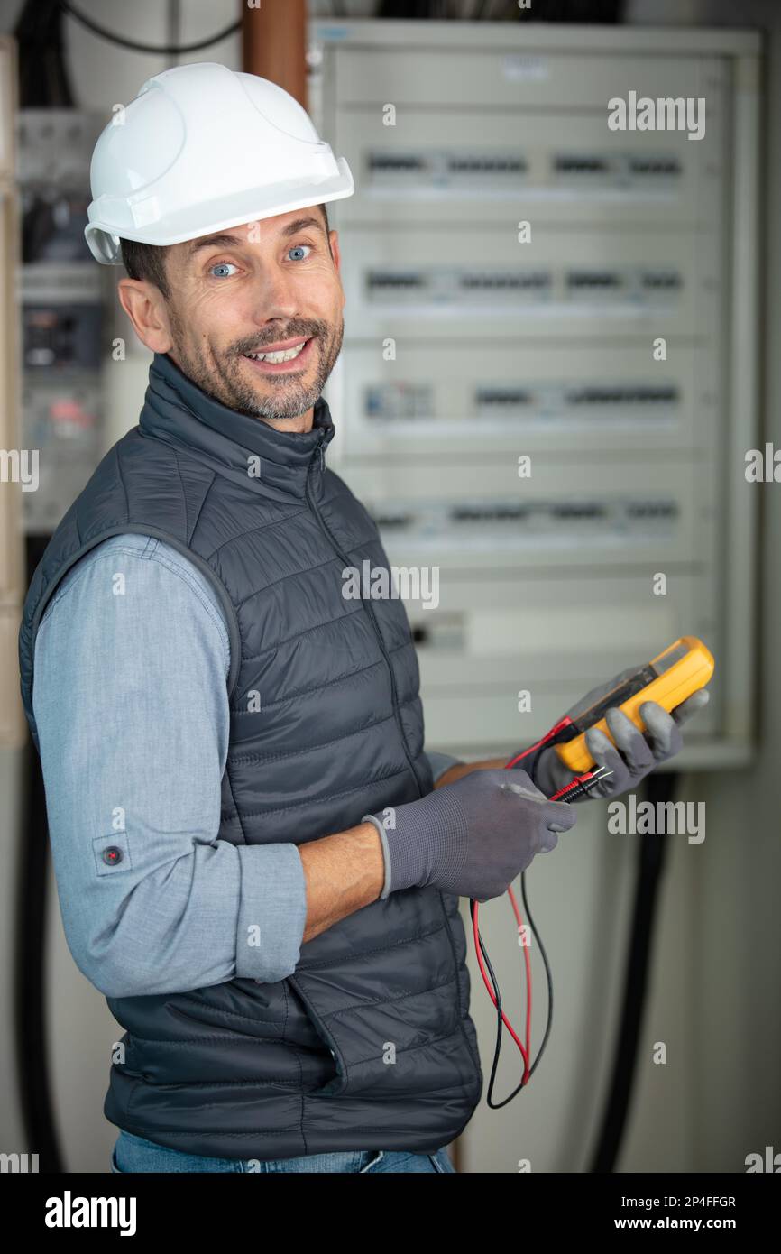 electrician using electric actuator equipment in fuse box Stock Photo ...