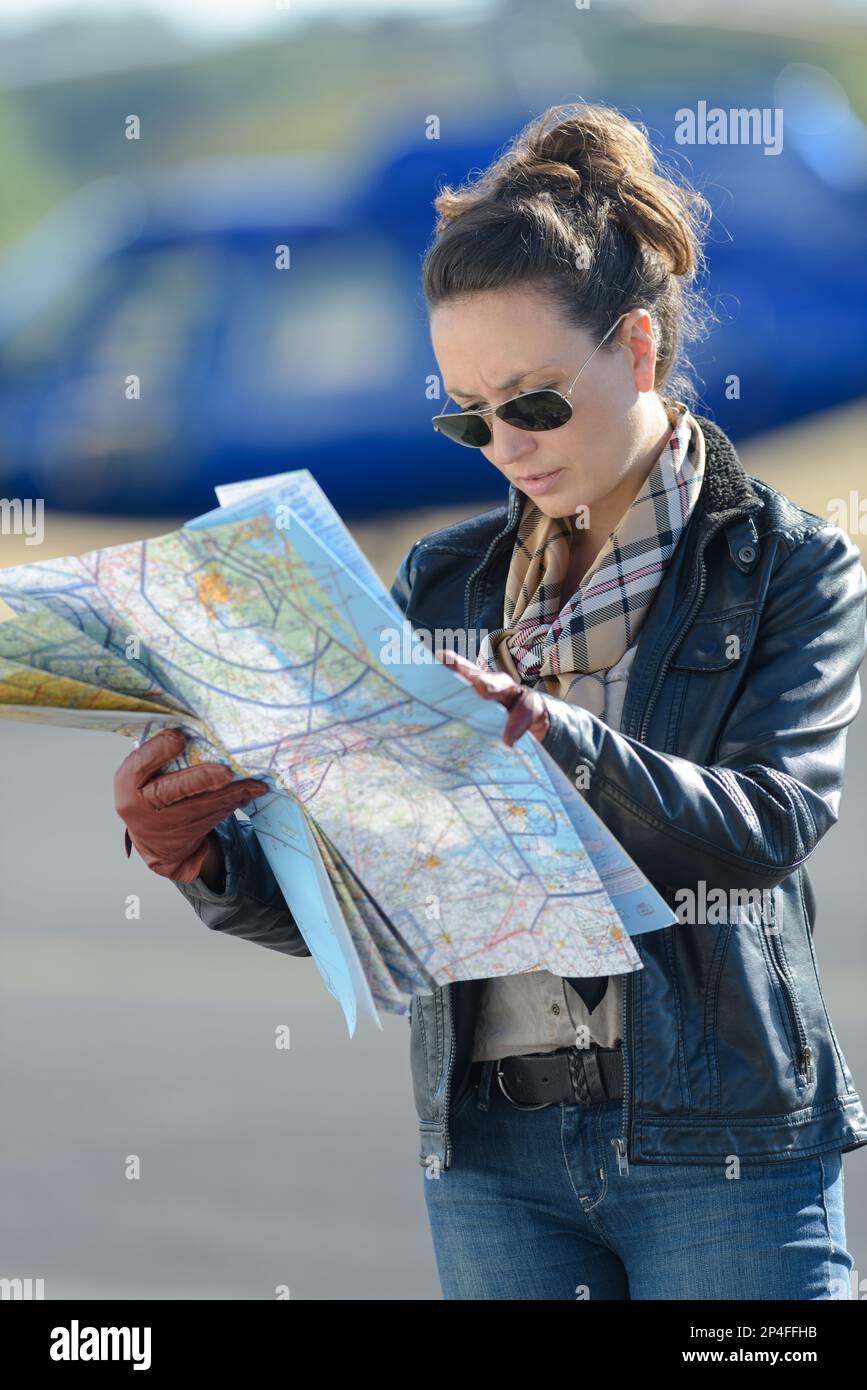 woman helicopter pilot reading map Stock Photo - Alamy