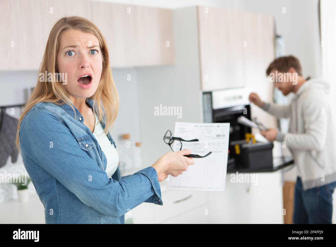 woman shocked and surprised with her electricity bills Stock Photo - Alamy