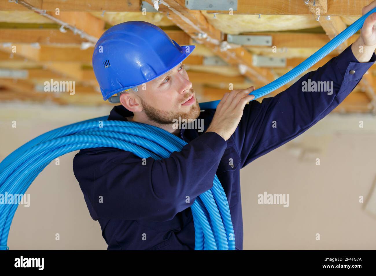 builder installing blue pvc pipe Stock Photo - Alamy