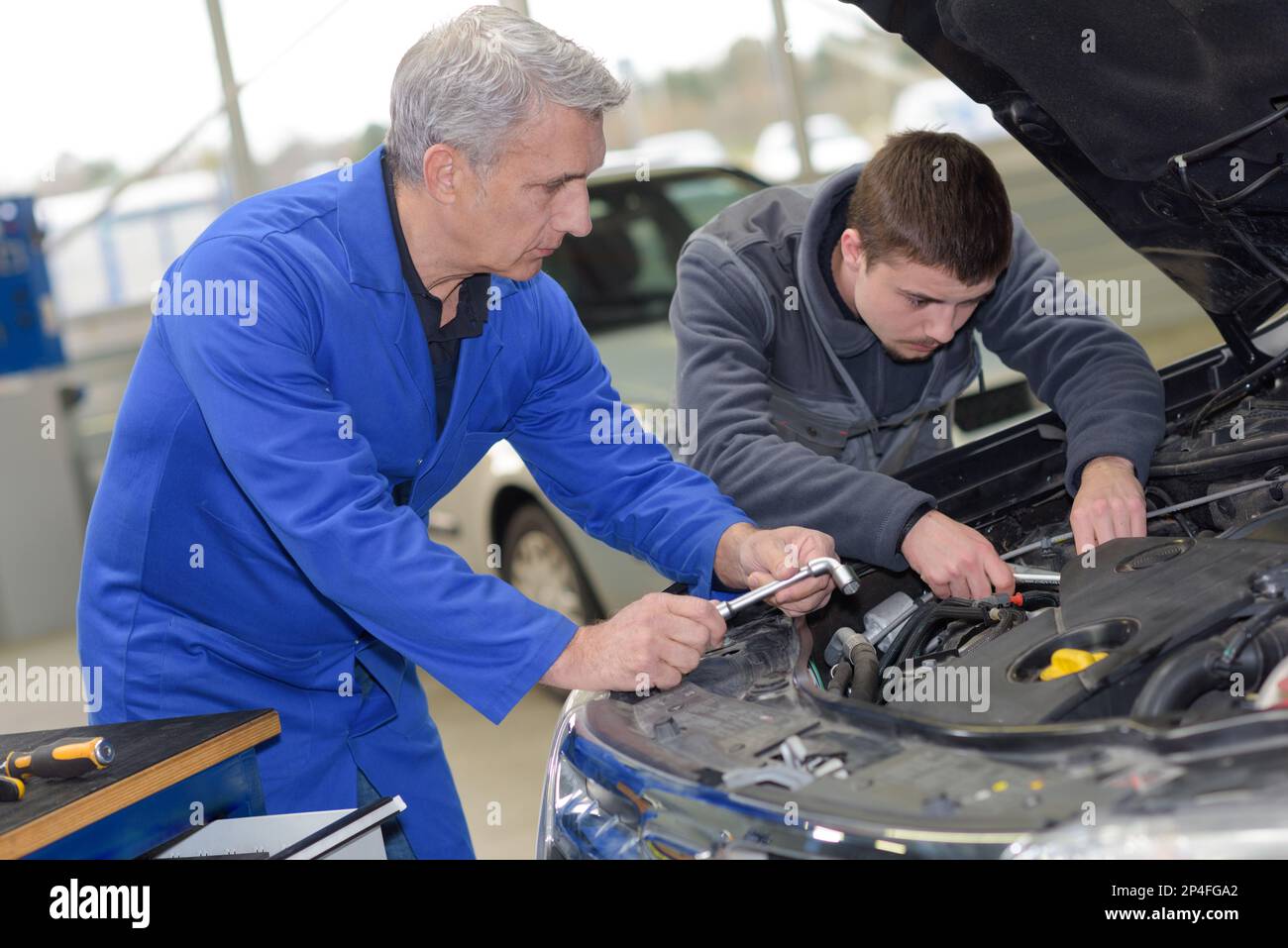 mechanics and the cars small parts Stock Photo - Alamy