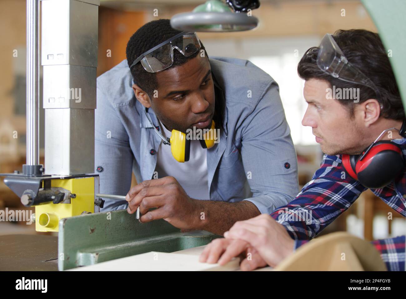 two men are measuring wood Stock Photo - Alamy