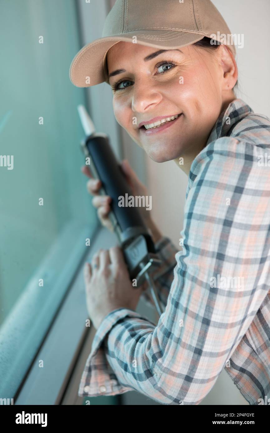 female builder installing window in a building Stock Photo - Alamy