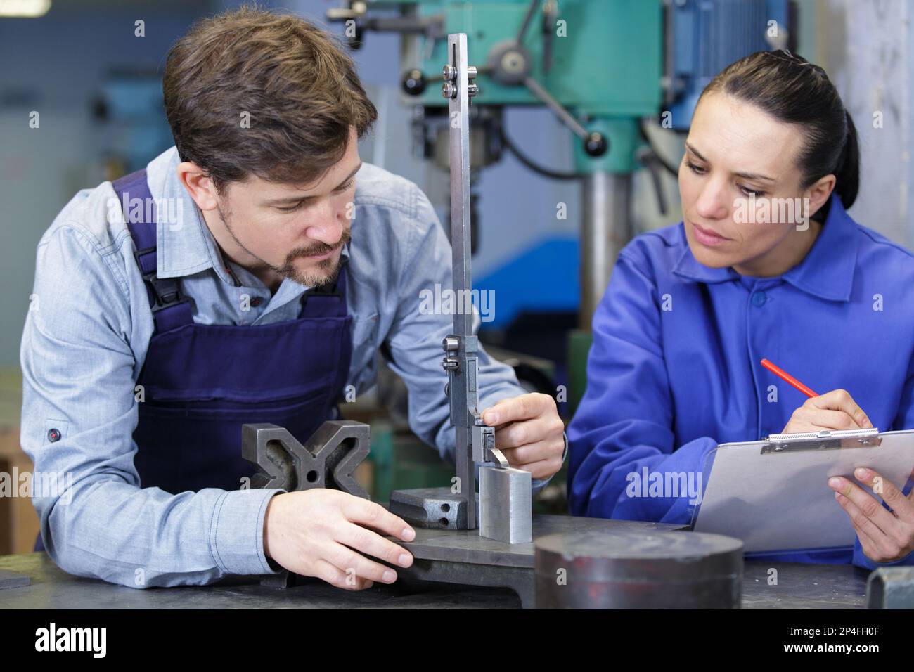engineer training apprentices on cnc machine Stock Photo - Alamy