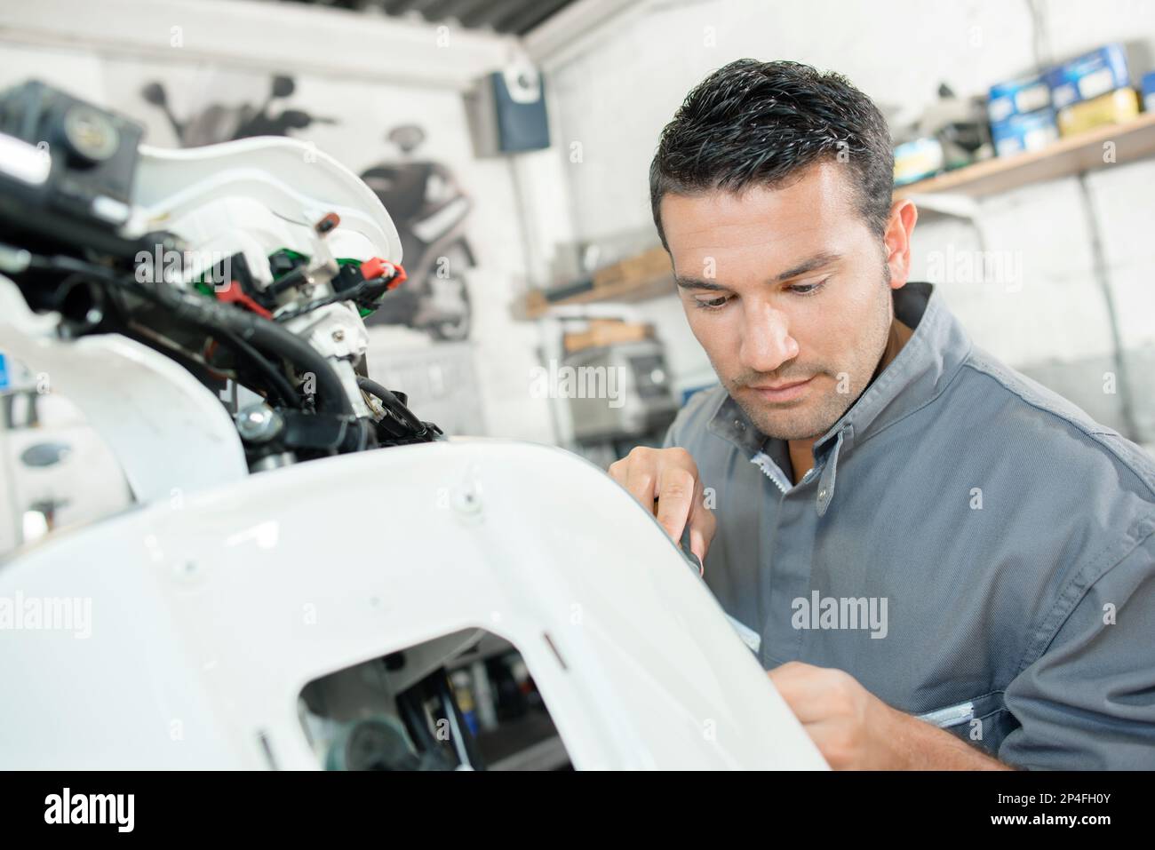 Mechanic repairing scooter hi-res stock photography and images - Alamy