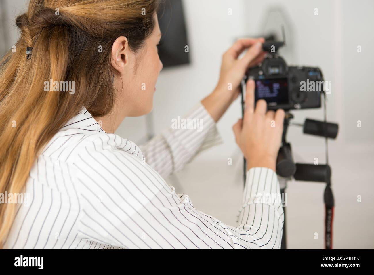 portrait of young atrractive woman photographer in studio Stock Photo ...