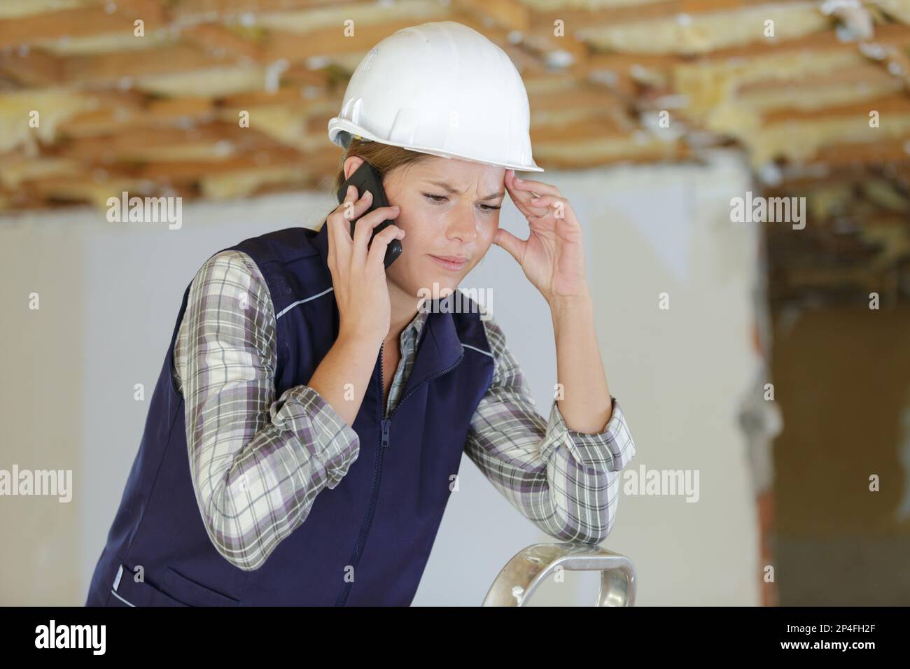 engineer girl with hard hat got headache Stock Photo - Alamy