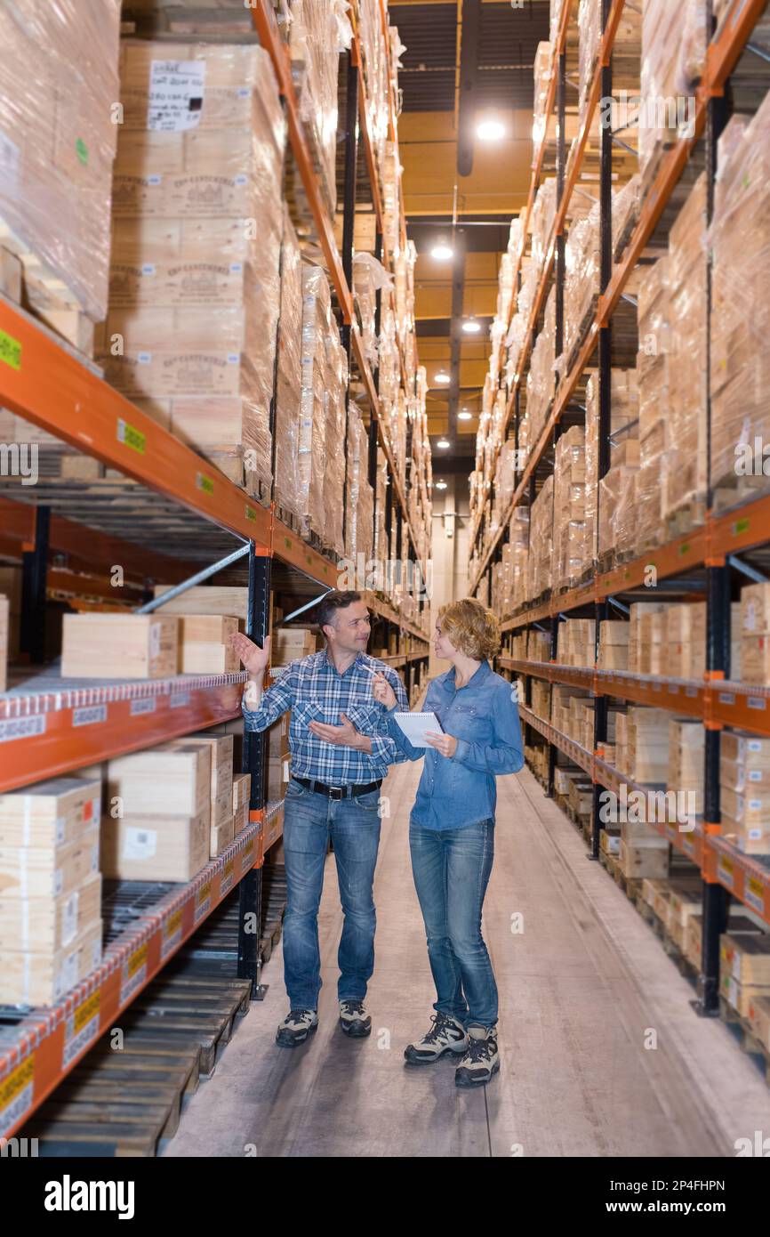 portrait of man and woman in warehouse Stock Photo - Alamy