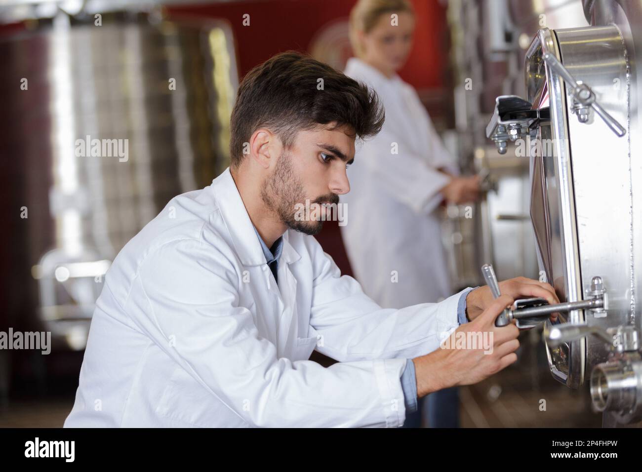 two food factory workers with metal vats Stock Photo - Alamy