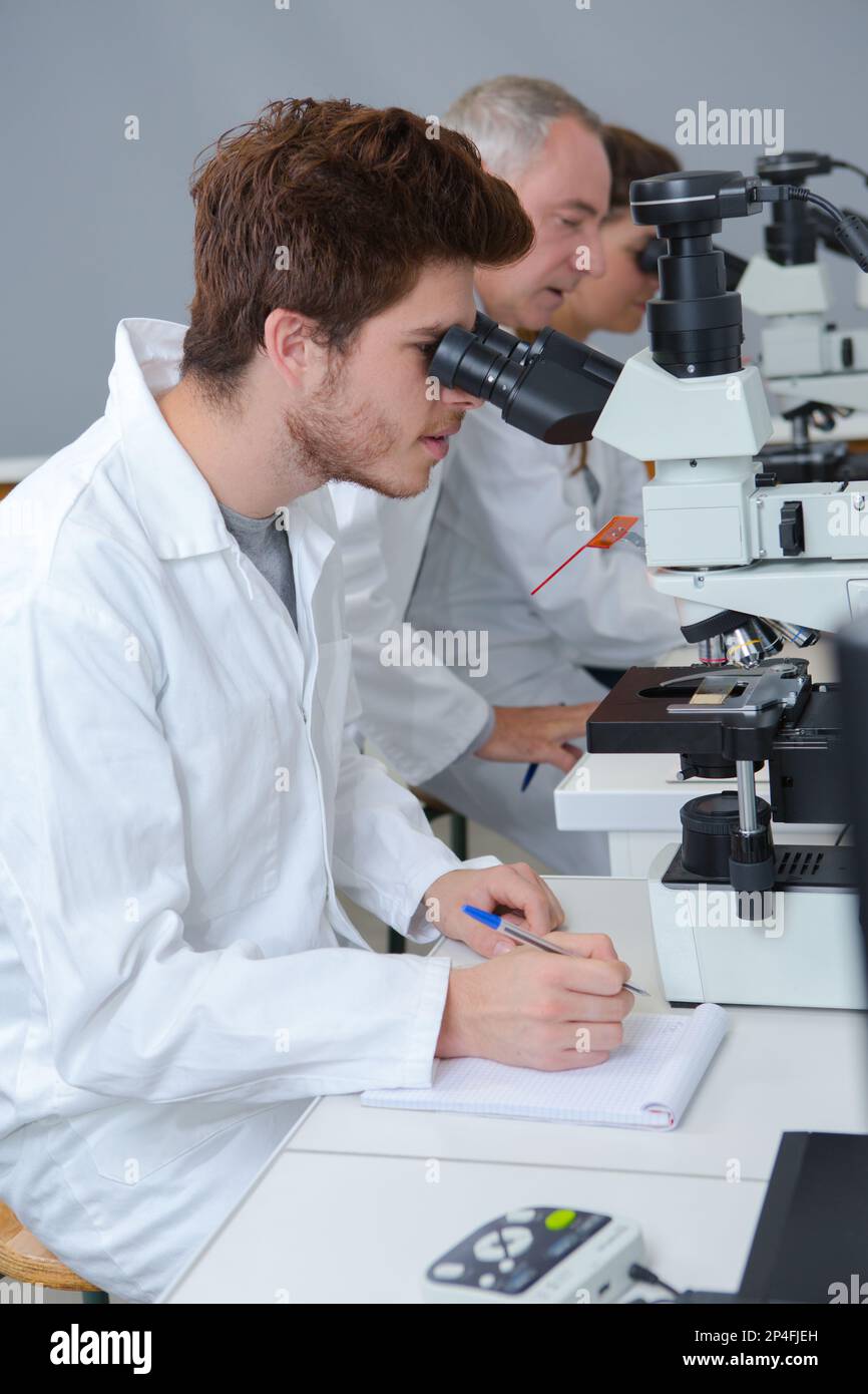 In school teacher using microscope hi-res stock photography and images ...