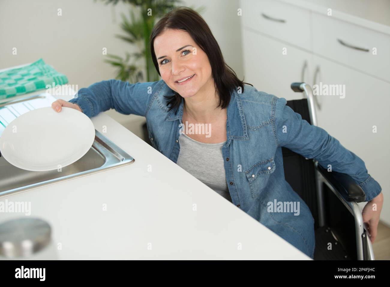 disabled woman doing house chores Stock Photo - Alamy