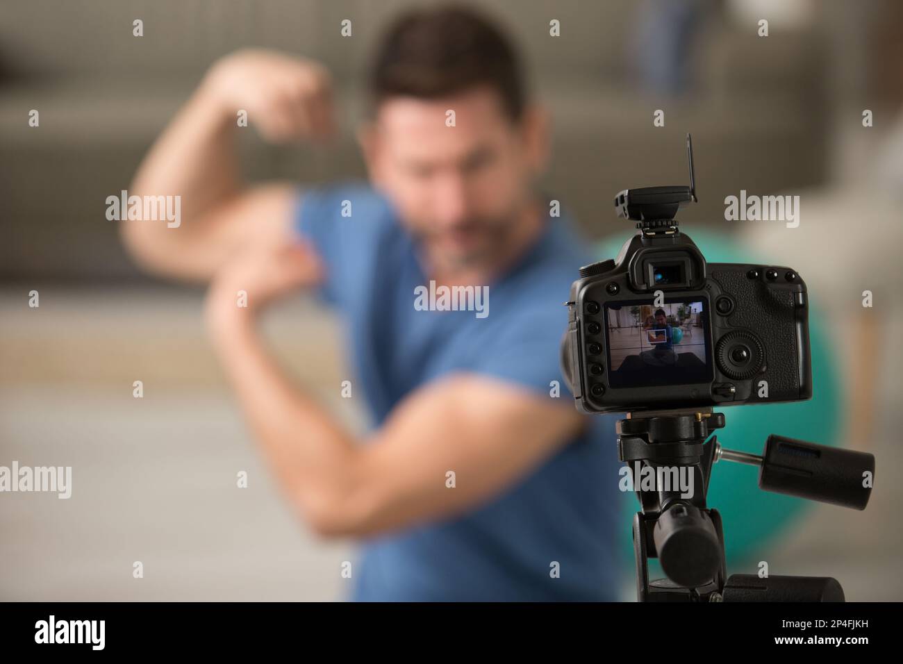 male fitness instructor making home video about muscle grow Stock Photo ...
