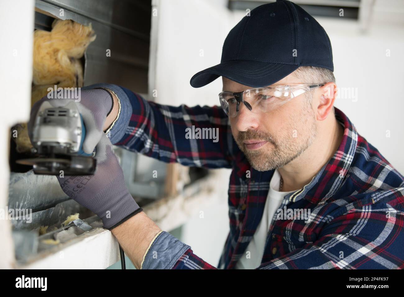 man worker using professional angle grinder for cutting wall Stock ...