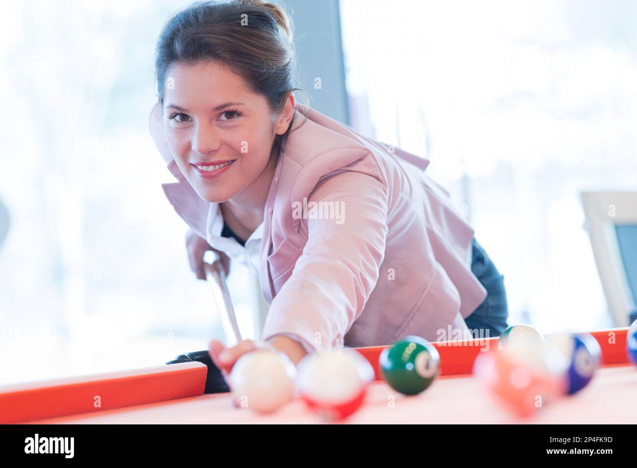 beautiful woman plays billiards in room Stock Photo - Alamy