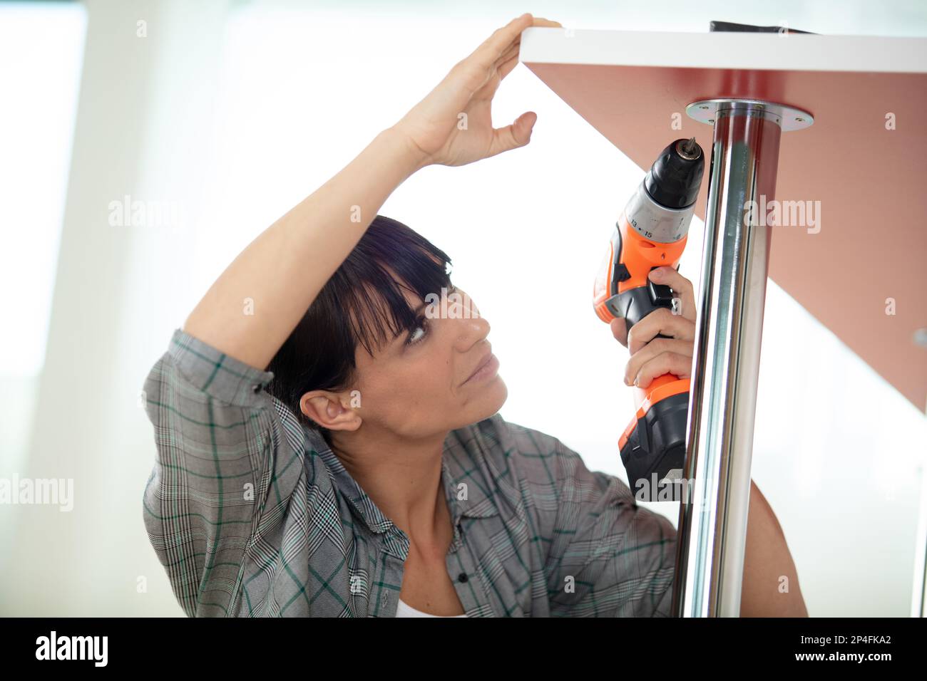 woman worker under the table Stock Photo - Alamy