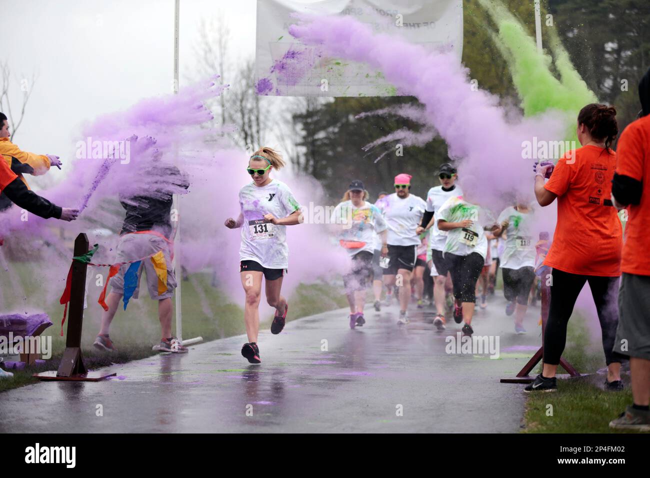 Courtney Decker is covered in an arc of colored powder as she crosses ...