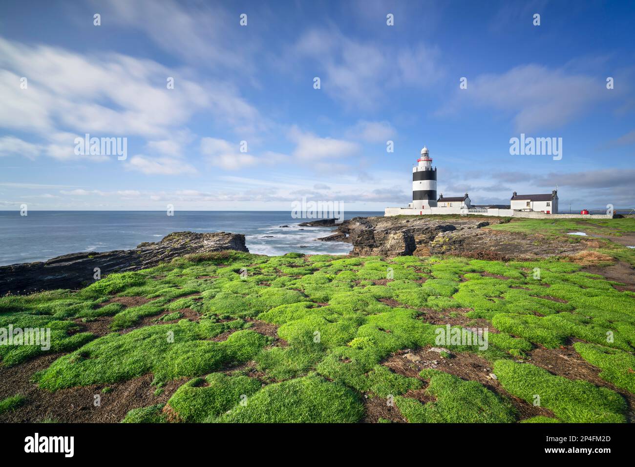 Hook Head lighthouse, blue sky and green grass, Wexford, Ireland Stock Photo - Alamy