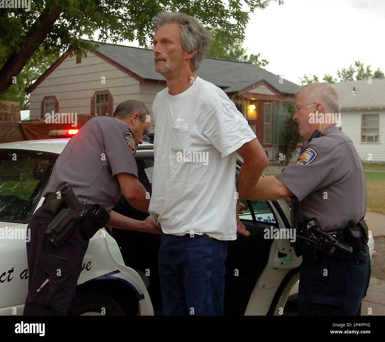 Enid Police Officers take a man into custody during a large-scale drug ...